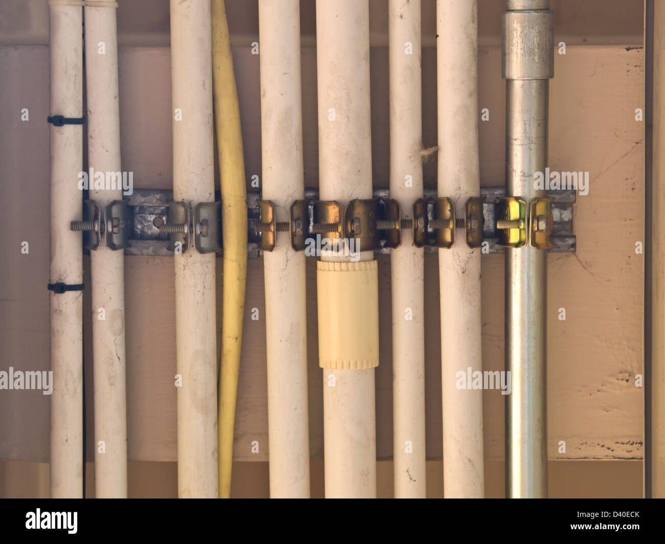 white pipes hanged on the white wall Stock Photo - Alamy