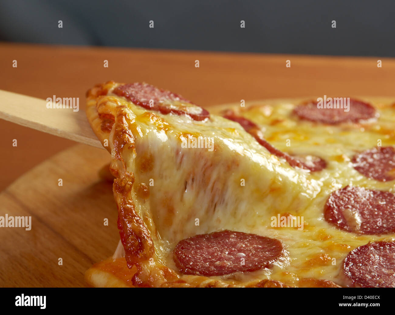 homemade pizza Pepperoni .taking slice of pizza,melted cheese dripping ...