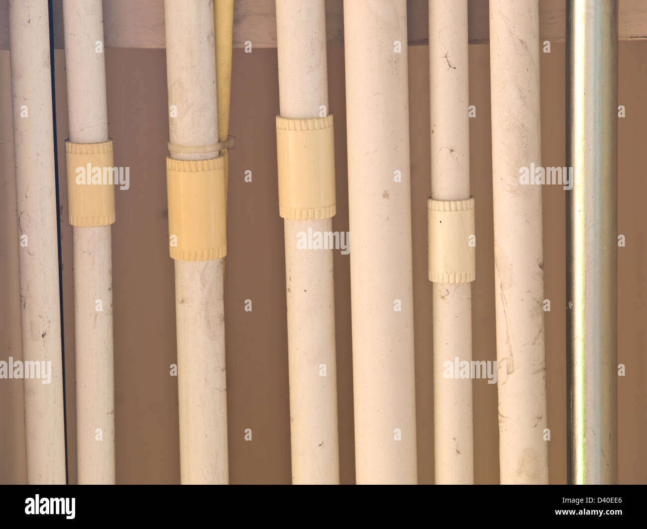 white pipes hanged on the white wall Stock Photo - Alamy