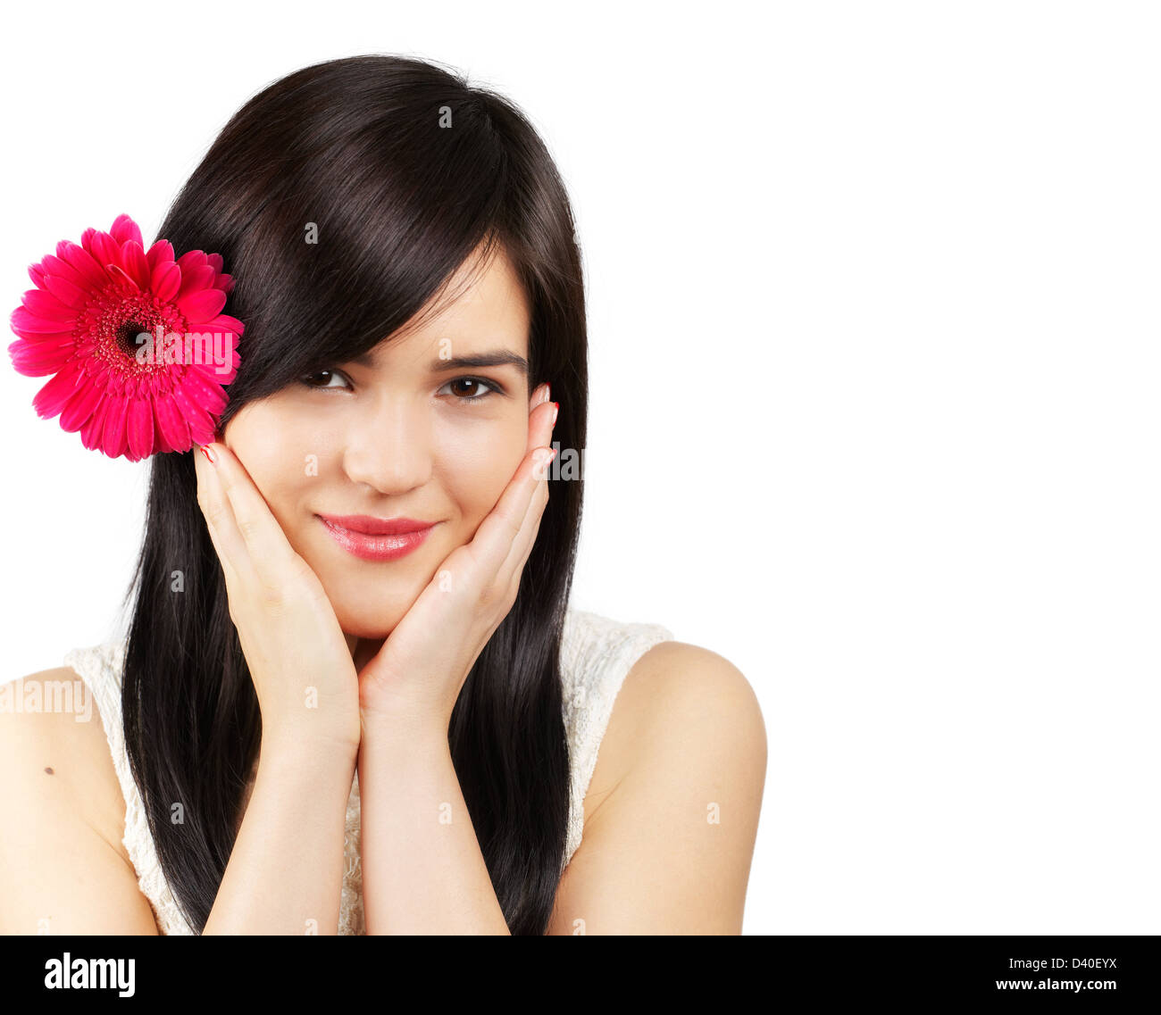 Portrait of a beautiful young woman with a flower on her ear isolated ...