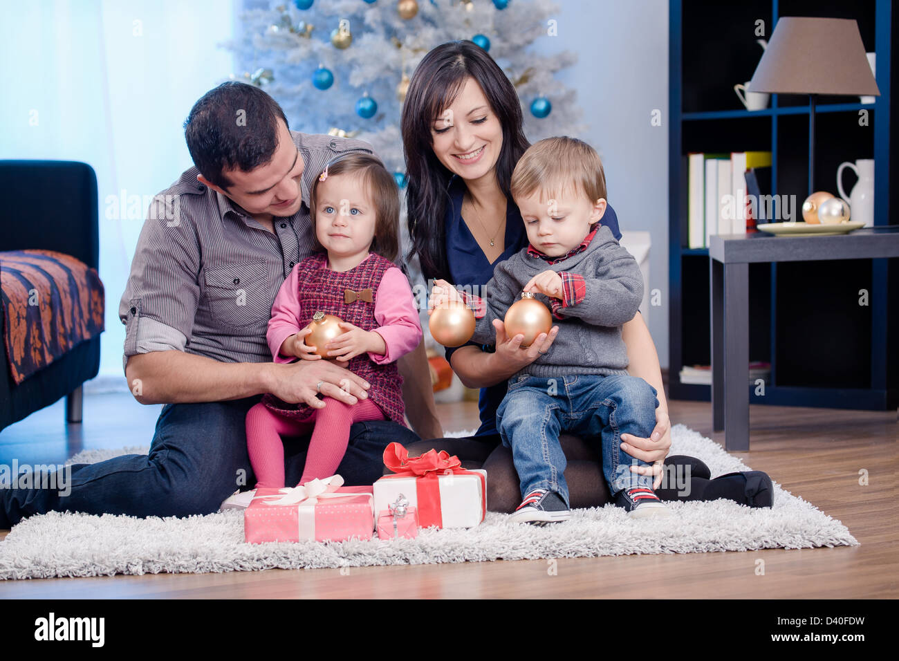 a young family getting Christmas gifts Stock Photo - Alamy