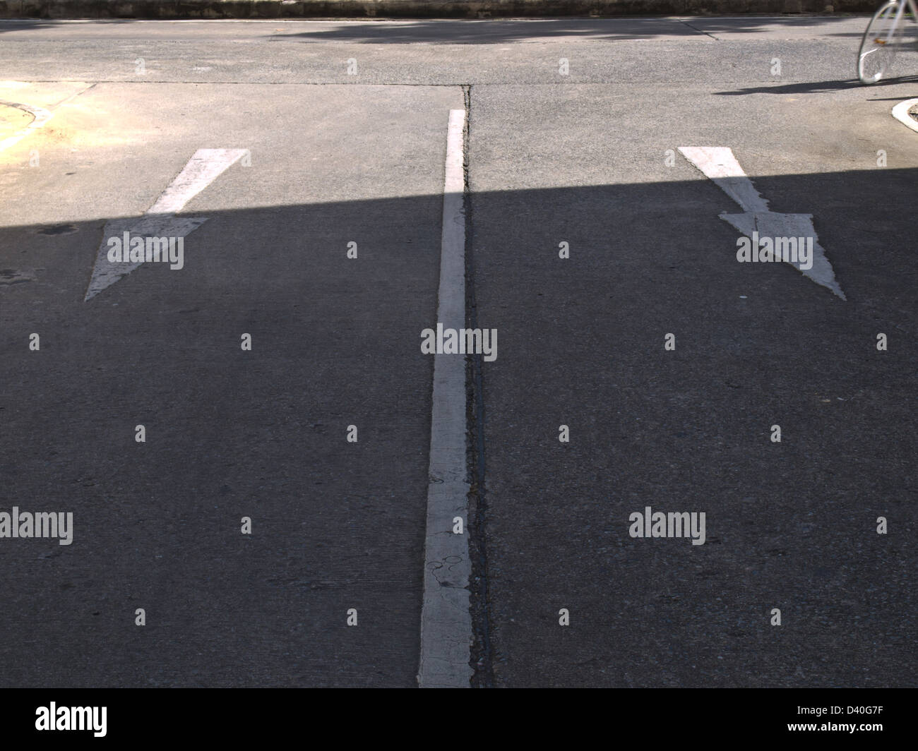White arrows on road pavement as background Stock Photo - Alamy