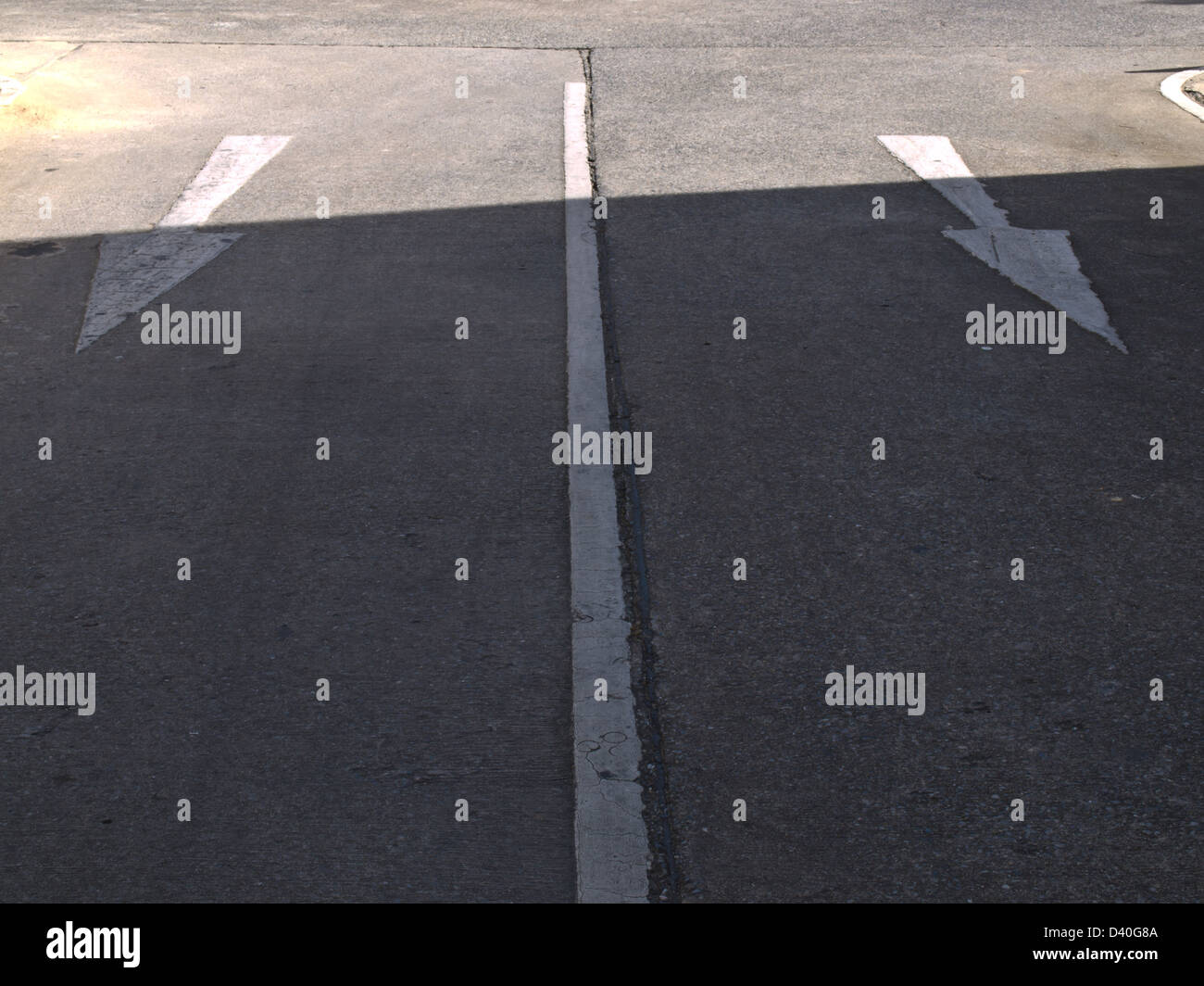 White arrows on road pavement as background Stock Photo - Alamy