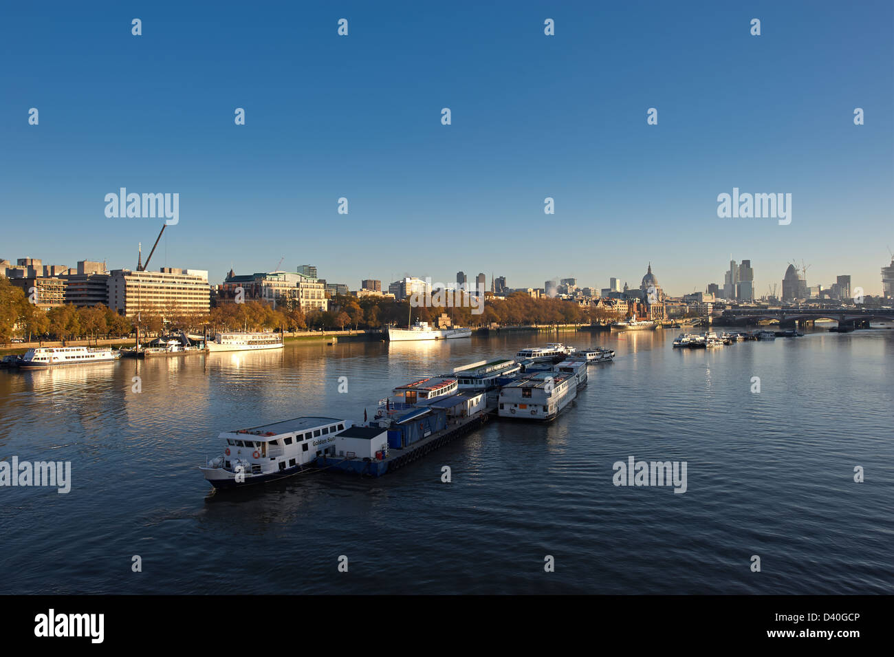 River Thames looking East from Waterloo Bridge at sunrise with boats in ...