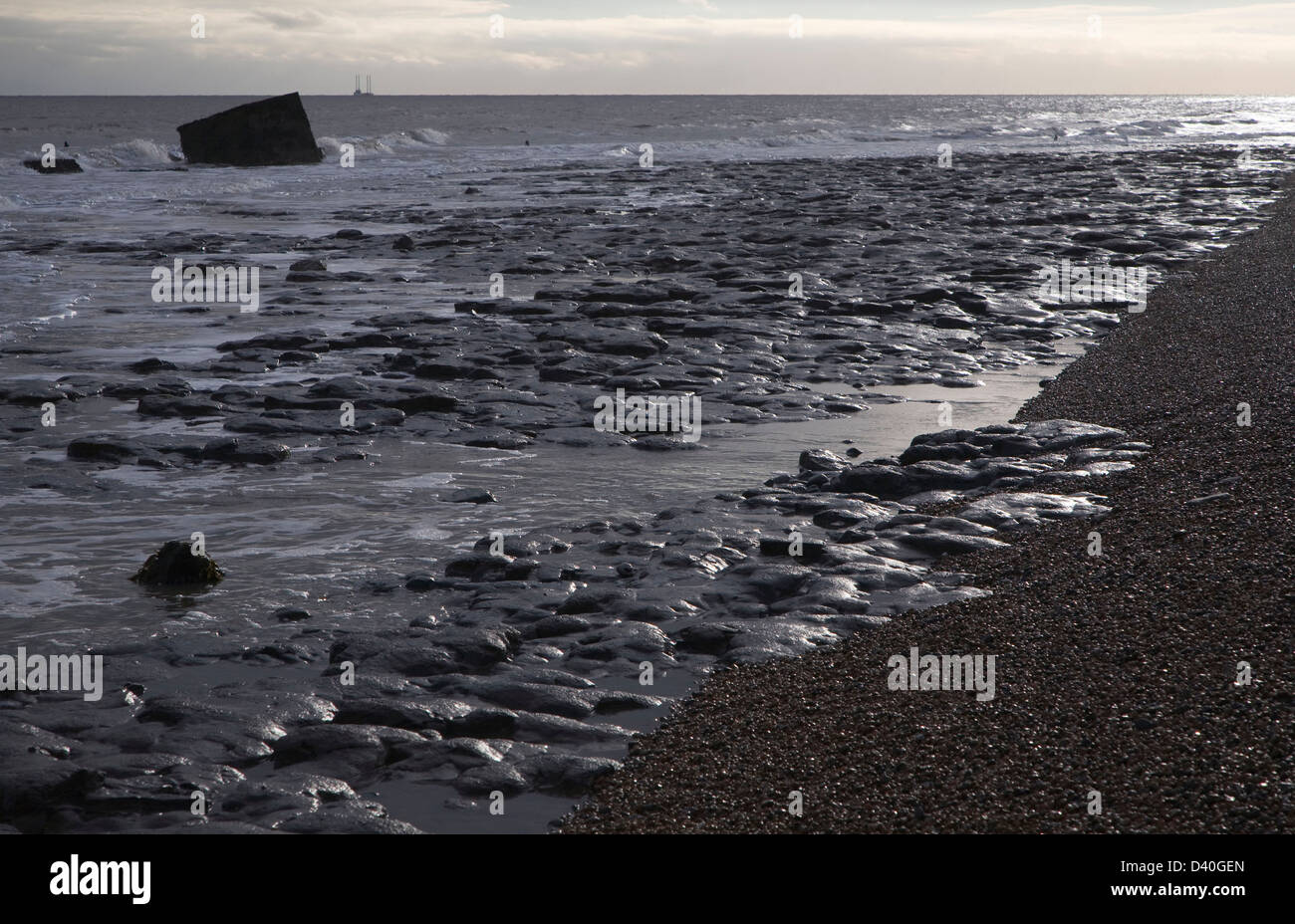 London Clay wave cut platform exposed at low tide on the beach at East ...