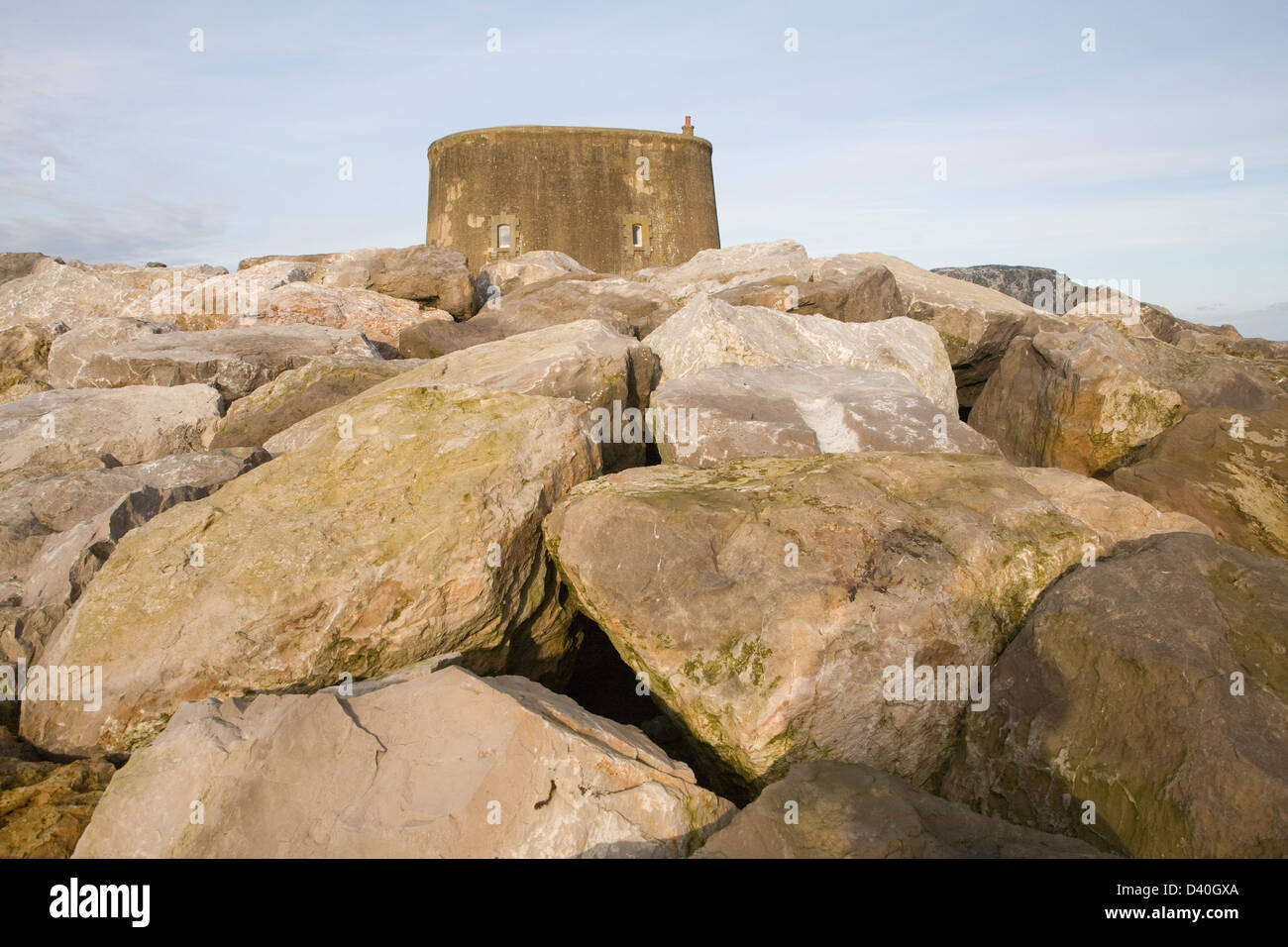 Martello tower defended from erosion by rock armour at East Lane ...