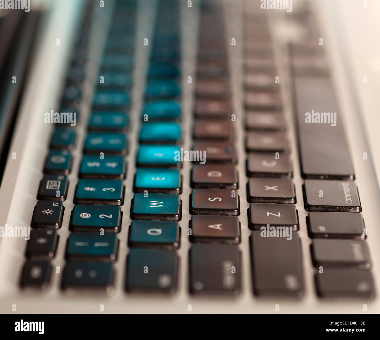 Laptop keyboard with blue tint of light Stock Photo - Alamy