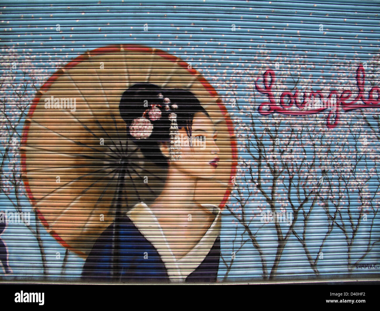 Japanese mural on shop front shutters as people walk past in Shoreditch ...
