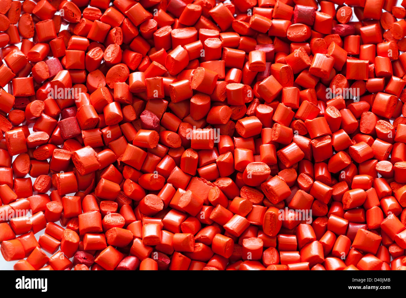 Red plastic masterbatch granules Stock Photo - Alamy