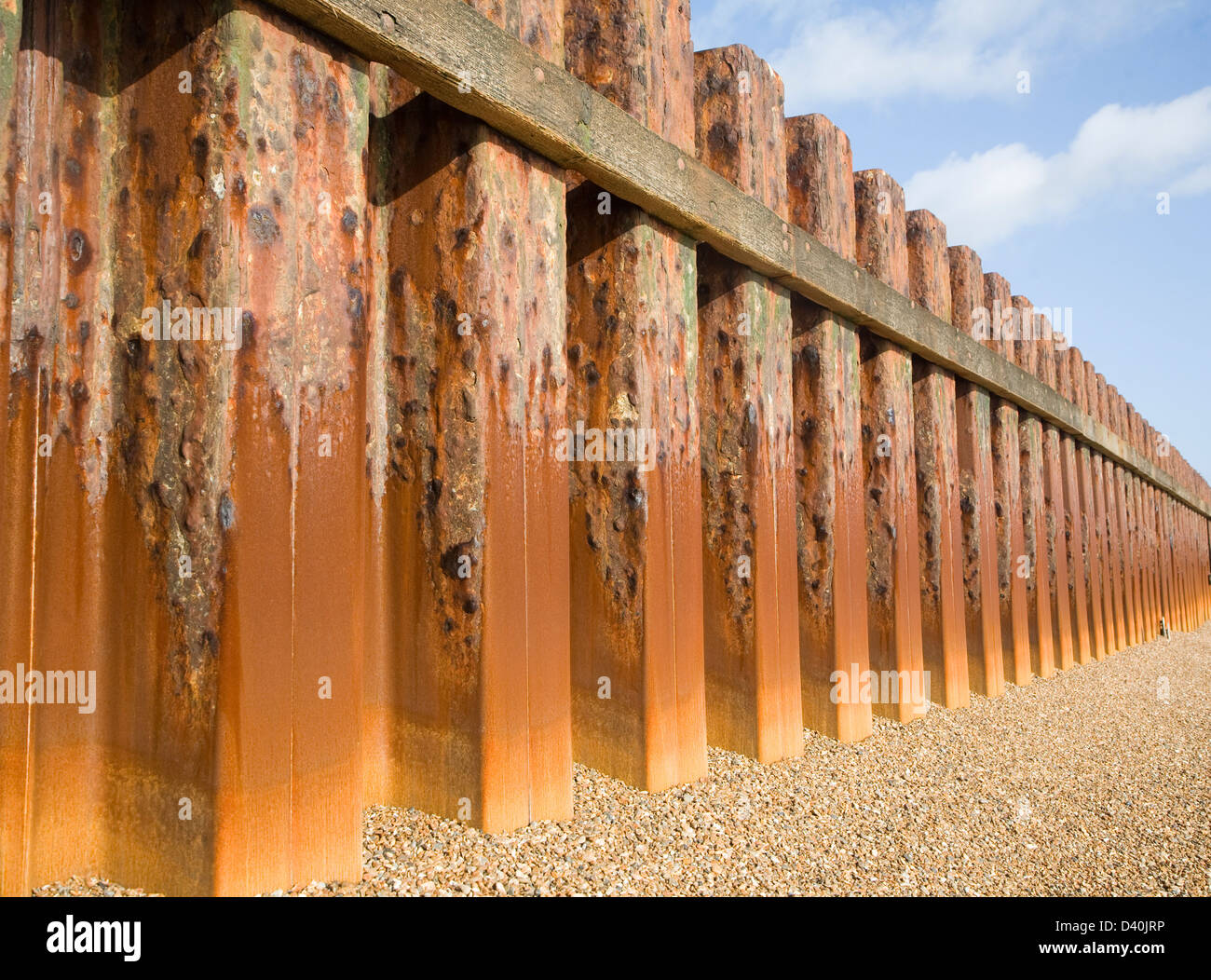 Rusty steel piling sea wall defences and shingle beach near Bawdsey ...