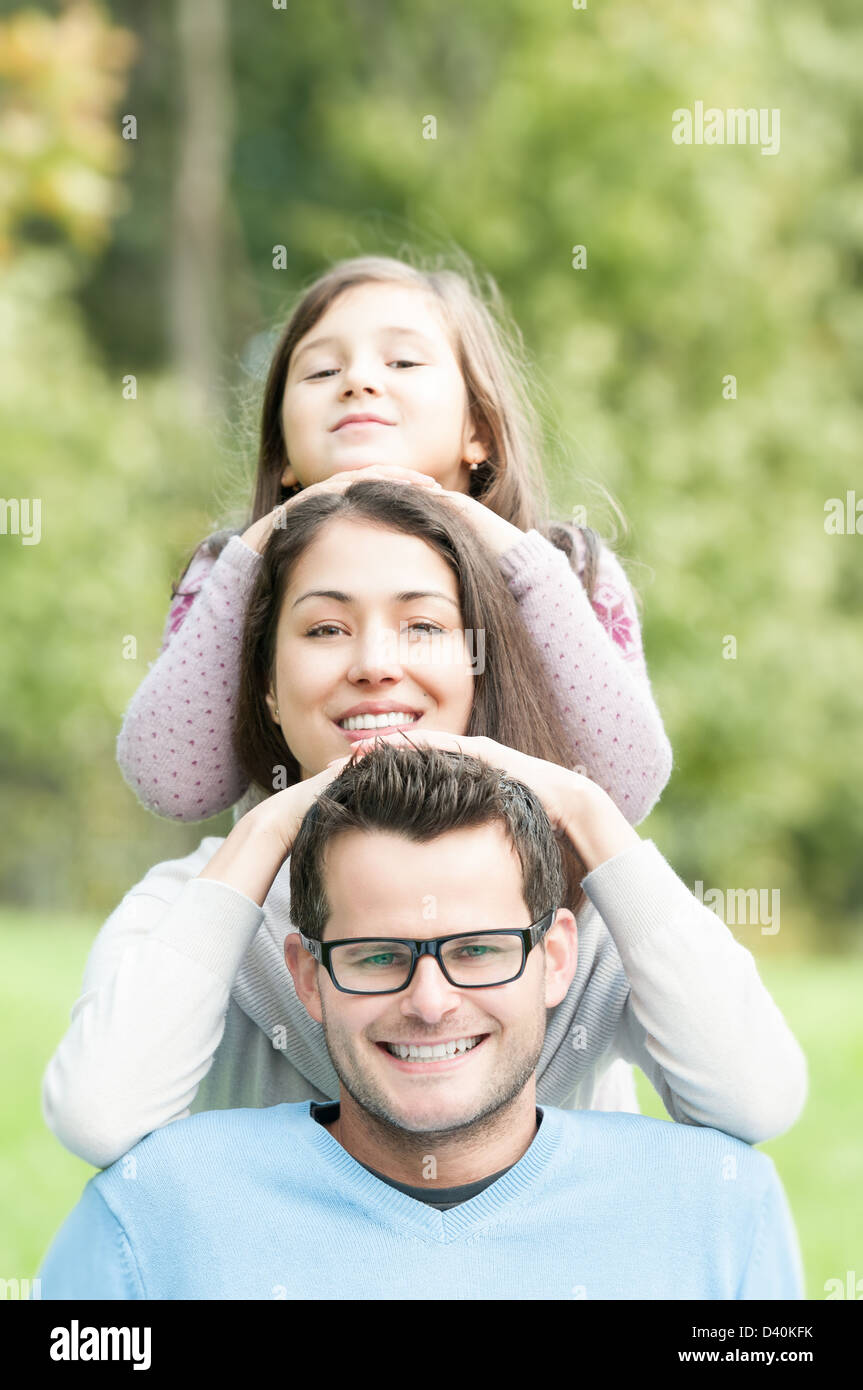 Pyramid of three family members. Cute girl above beautiful woman and ...