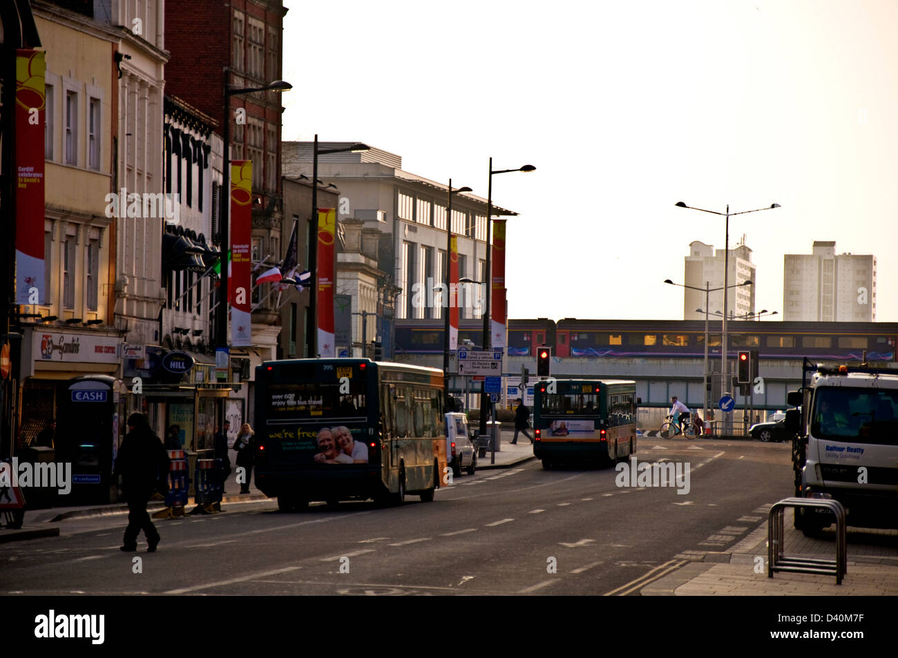Early morning in Cardiff City people getting to work by bus train ...