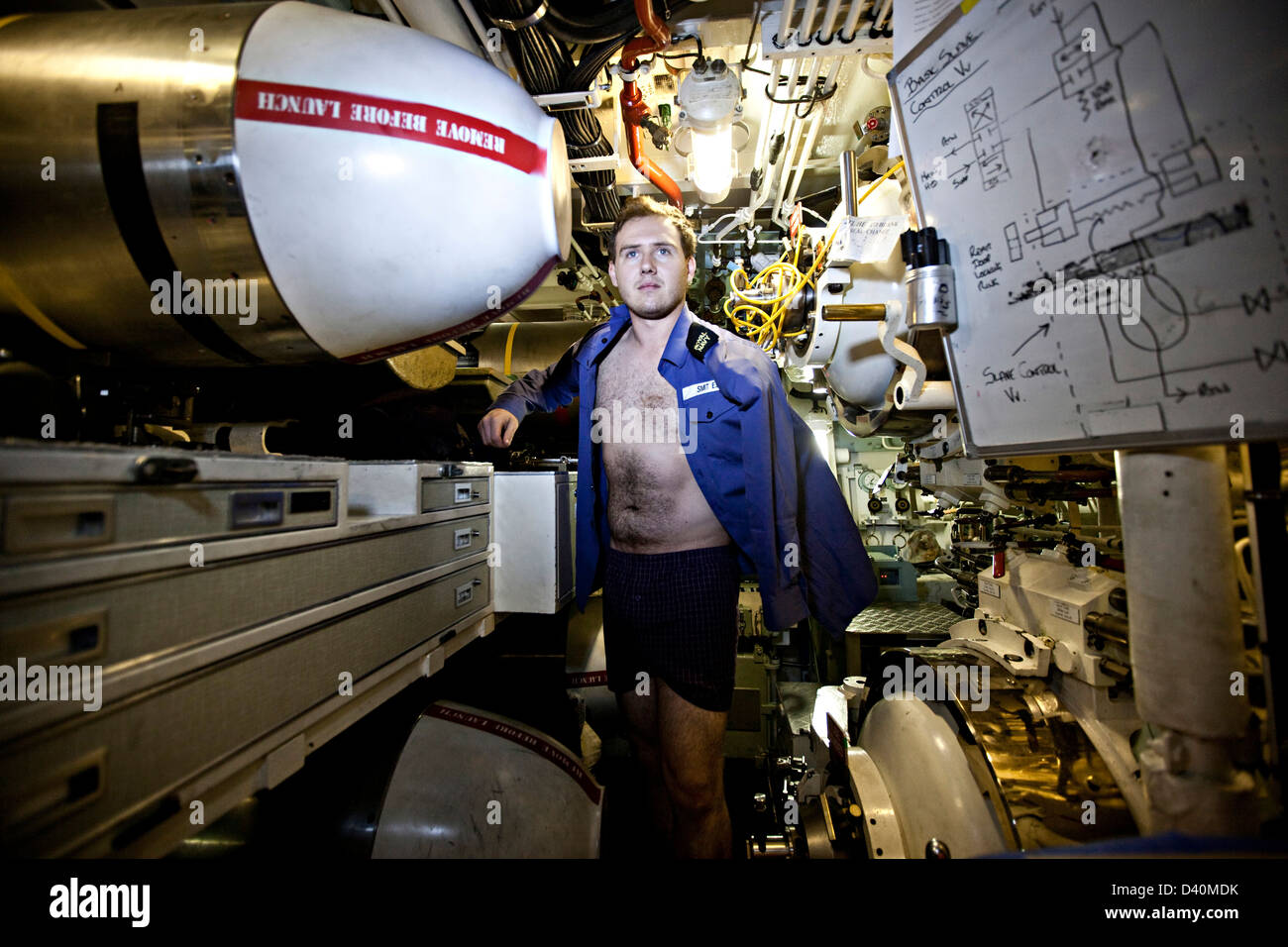 Crew man in pyjamas in torpedo room of Nuclear Submarine HMS Talent ...