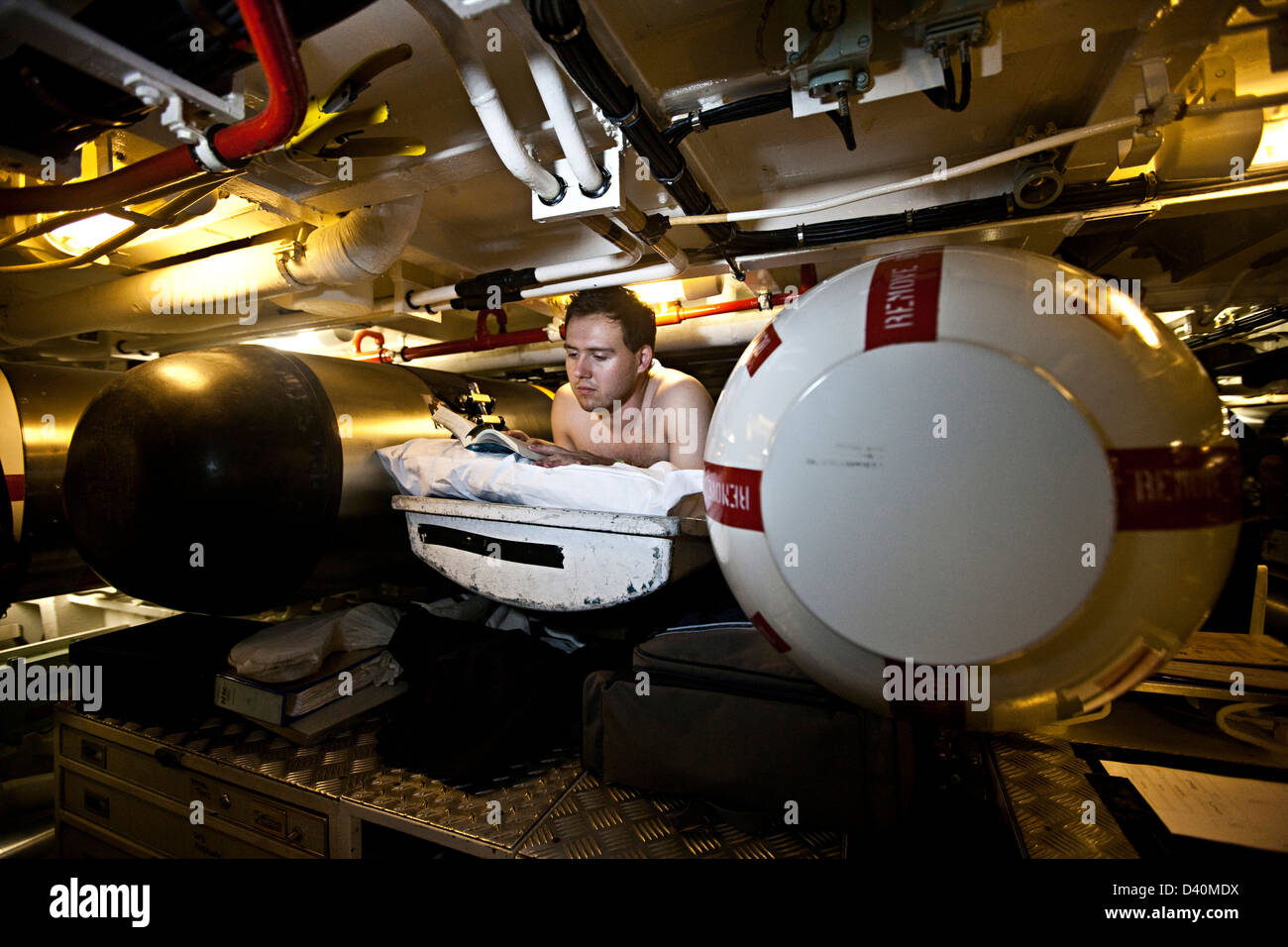 Man in bunk with torpedoes in Nuclear Submarine HMS Talent Stock Photo ...