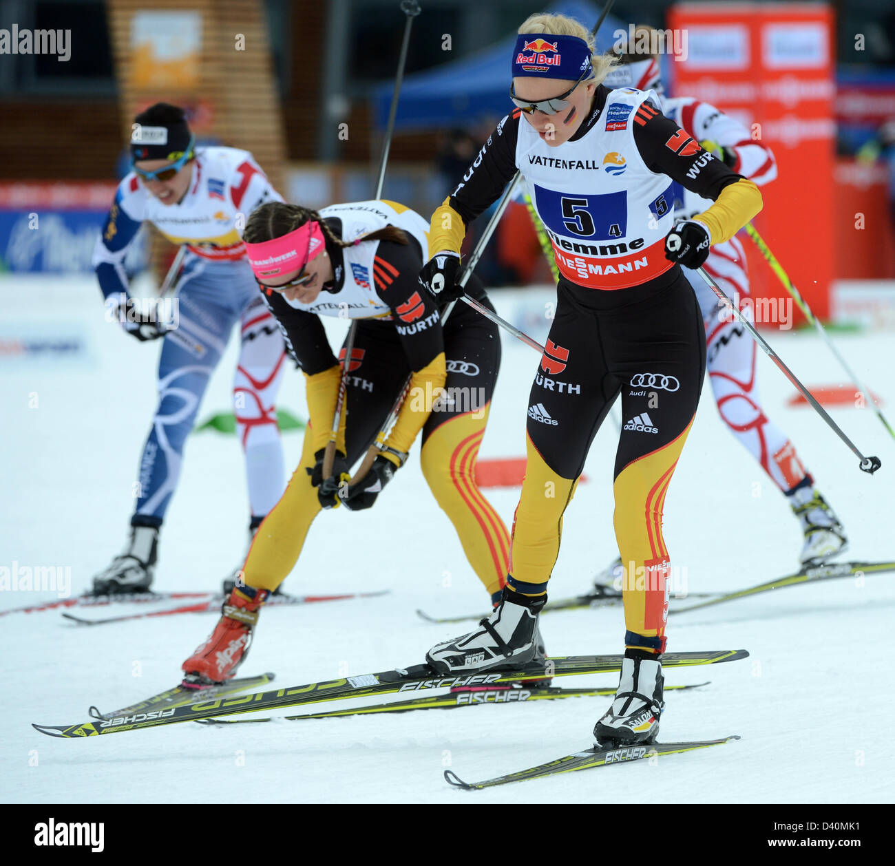 Denise Herrmann (C) and Miriam Goessner (R) of Germany compete during ...