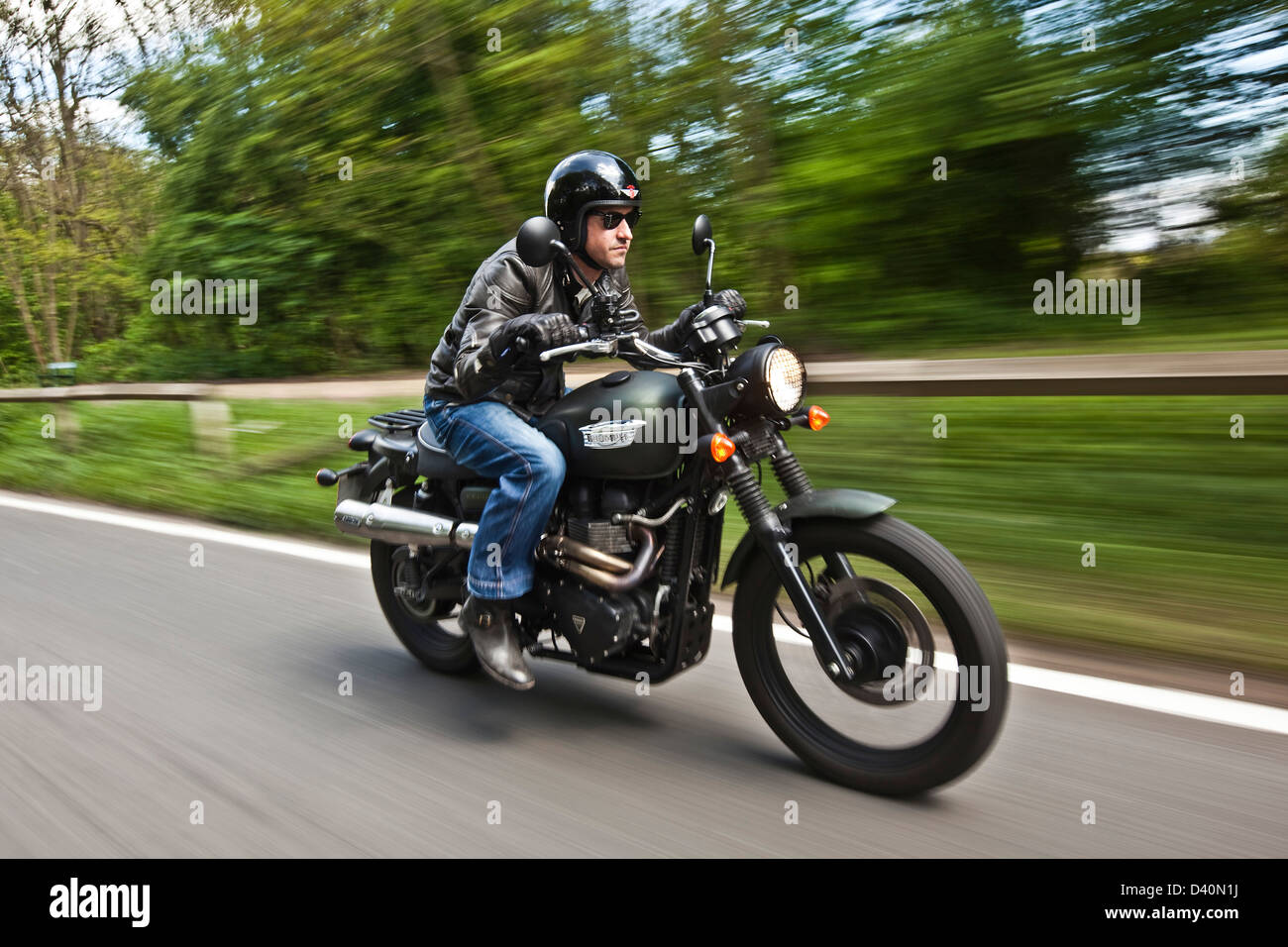 Man in black leathers on Triumph scrambler motorbike, London Stock ...
