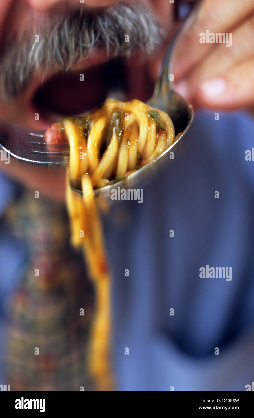 A man with a mustache eats spaghetti Stock Photo - Alamy