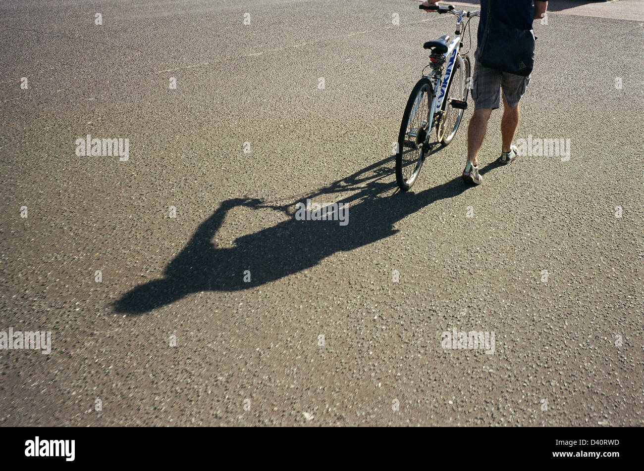Shadow, man pushing bicycle, Brighton and Hove, UK Stock Photo - Alamy