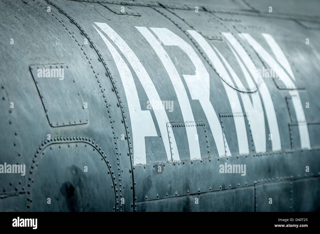 Close-up side view of military airplane with big white army inscription ...