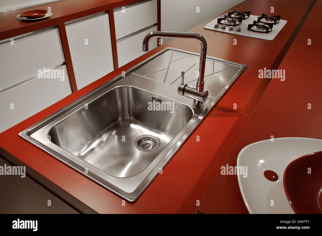 contemporary cuisine in a bright red metal sink with tap water Stock ...