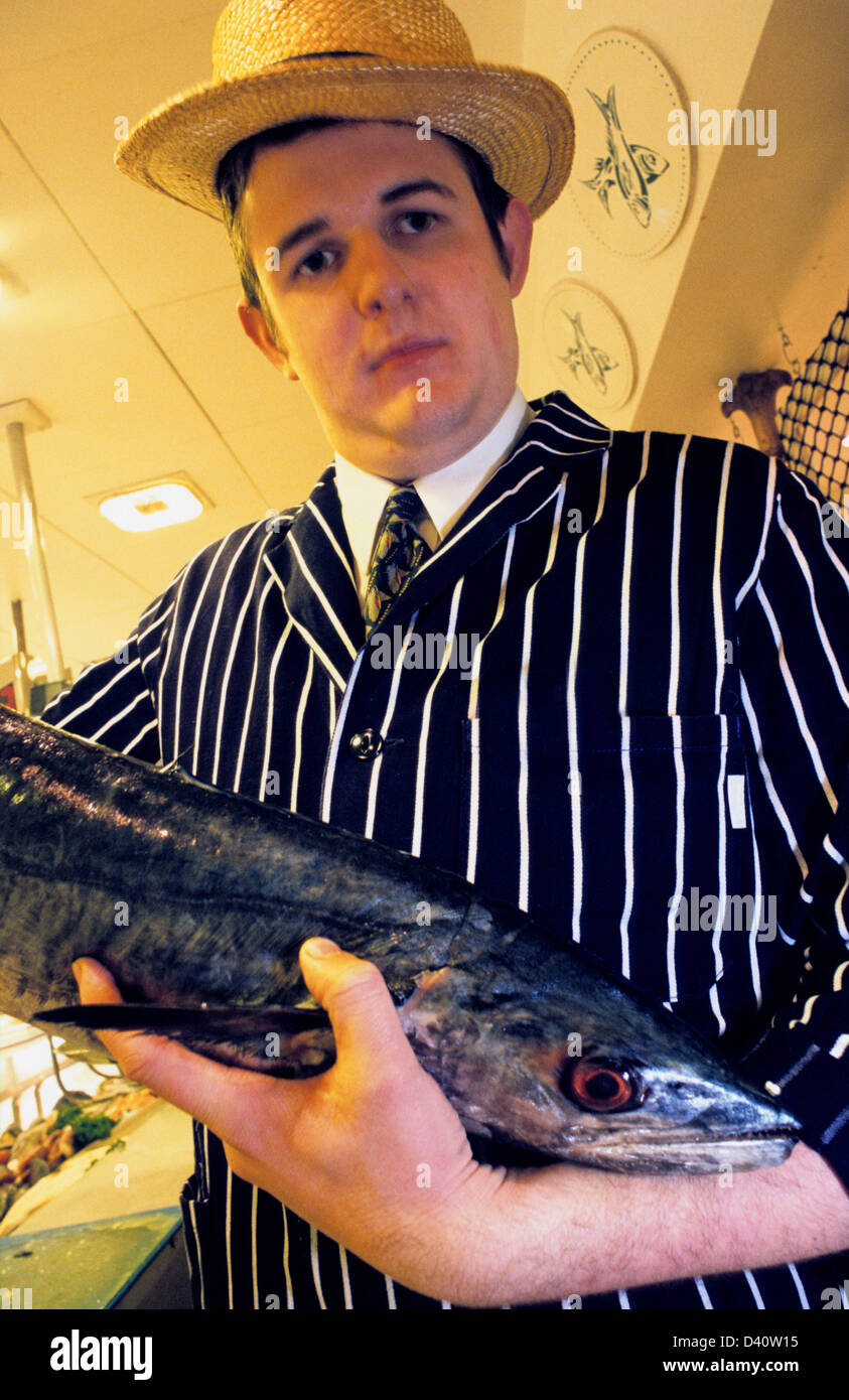 A fishmonger with fish Stock Photo - Alamy