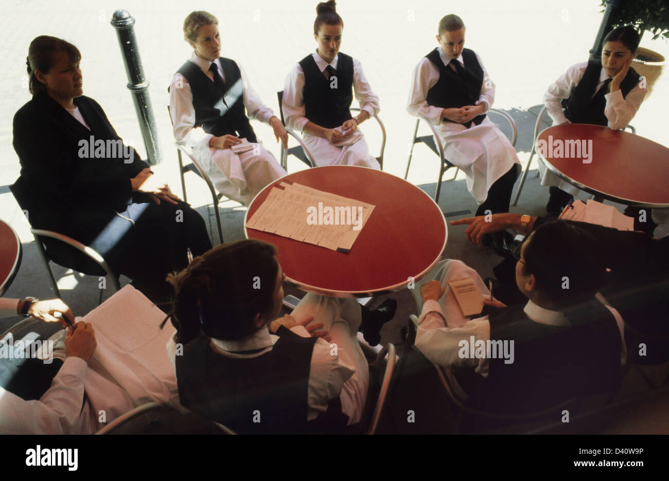 Waiting staff being briefed before the working day begins Stock Photo ...
