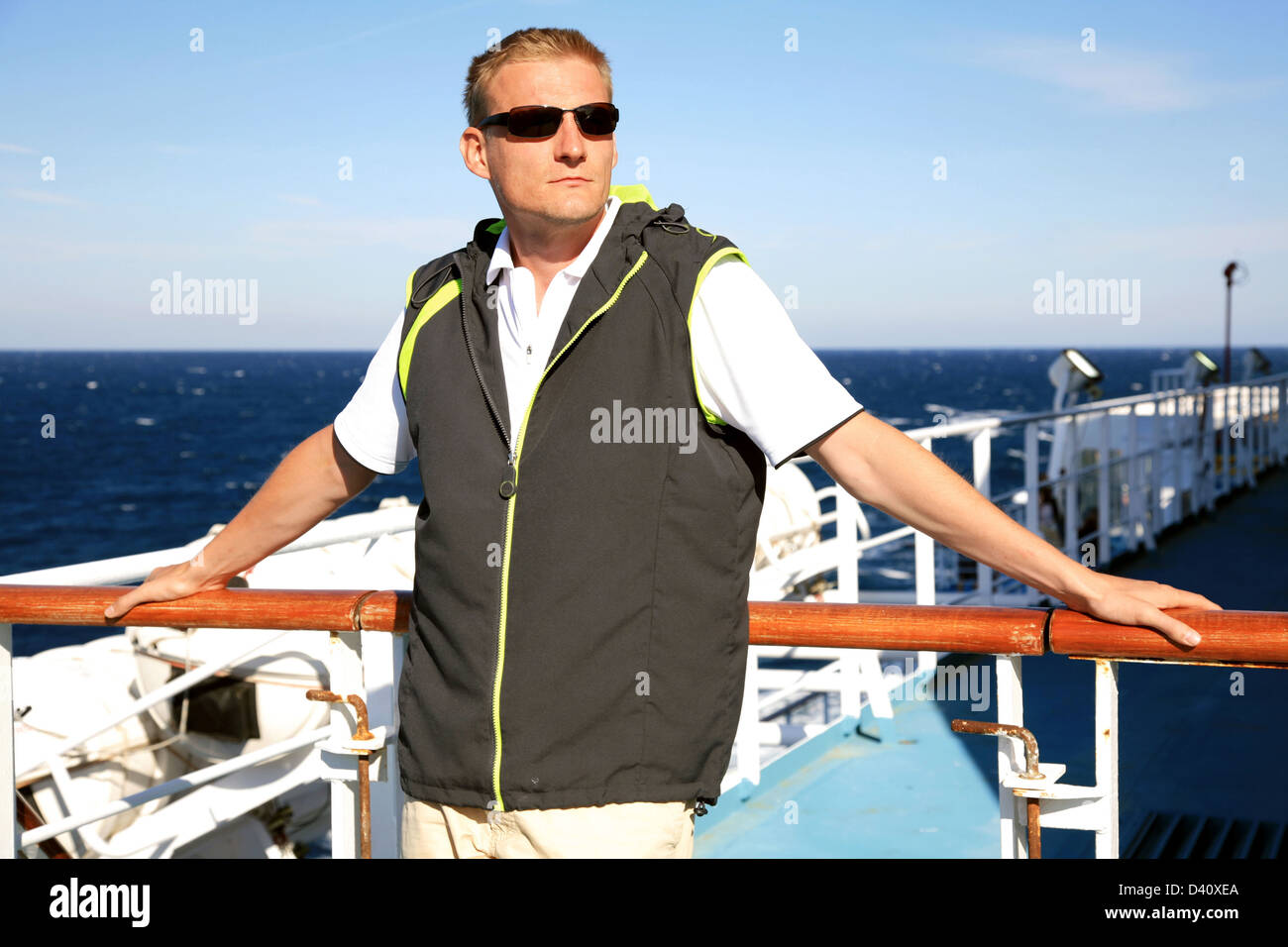 Man on ferry during cruise on vacation Stock Photo - Alamy