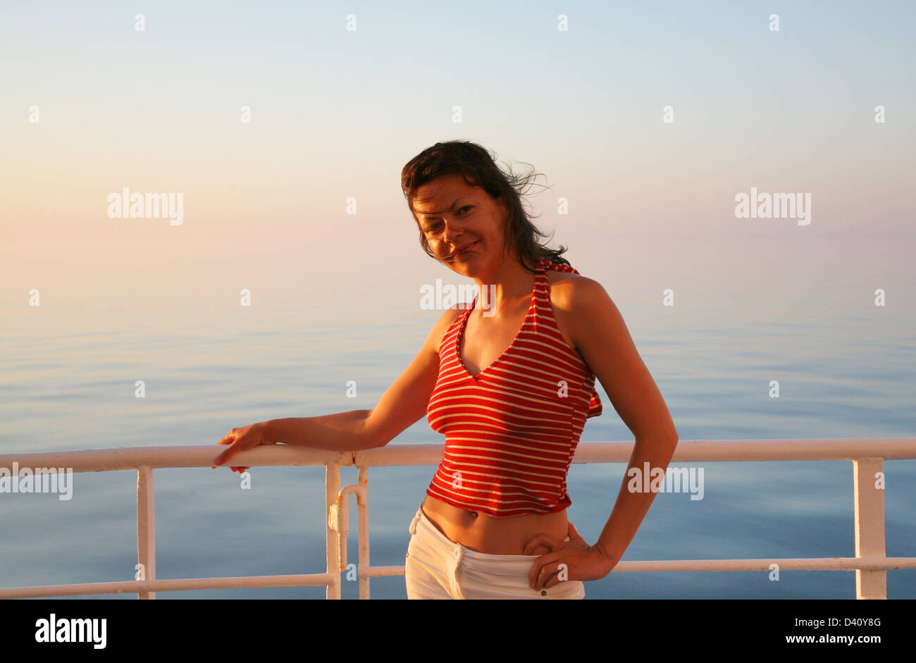 Happy lady on liner during cruise sunset Stock Photo - Alamy