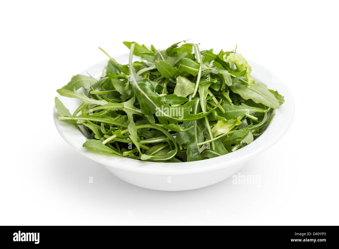 fresh rucola leaves in a bowl, isolated on white Stock Photo - Alamy