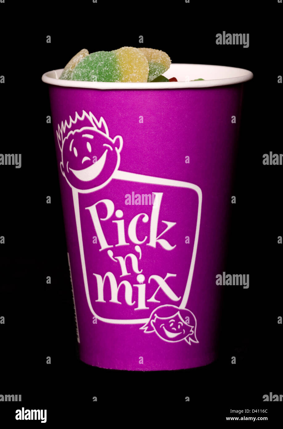 Pick and mix sweets in a pink tub on black background Stock Photo - Alamy