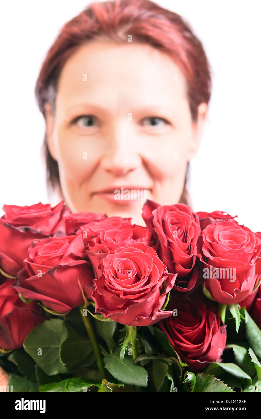 The woman of middle age with a bouquet of red roses, focus on a ...