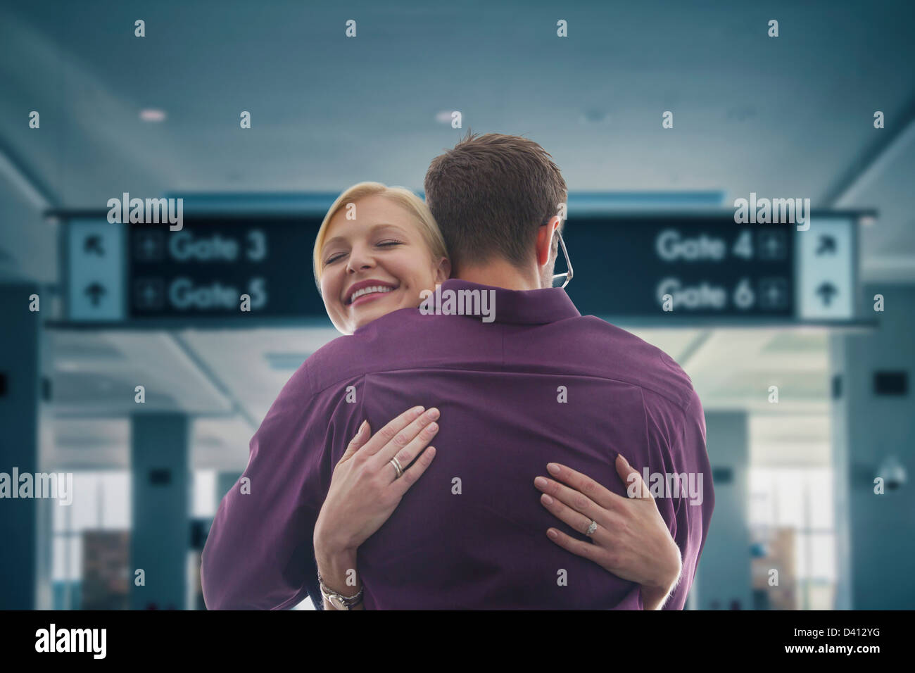 Caucasian hugging in airport Stock Photo - Alamy