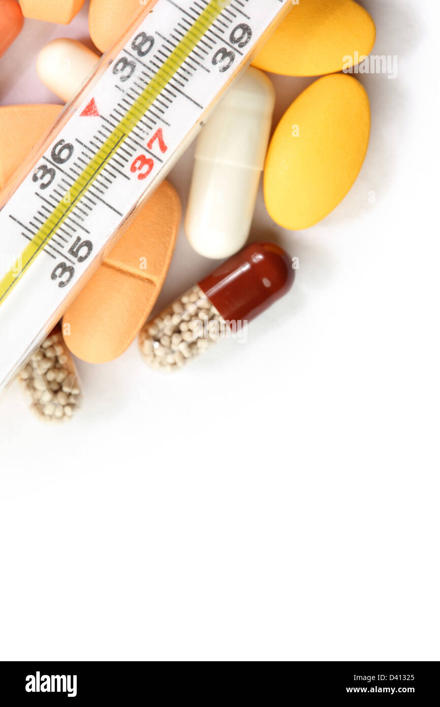 Pills and thermometer Stock Photo - Alamy