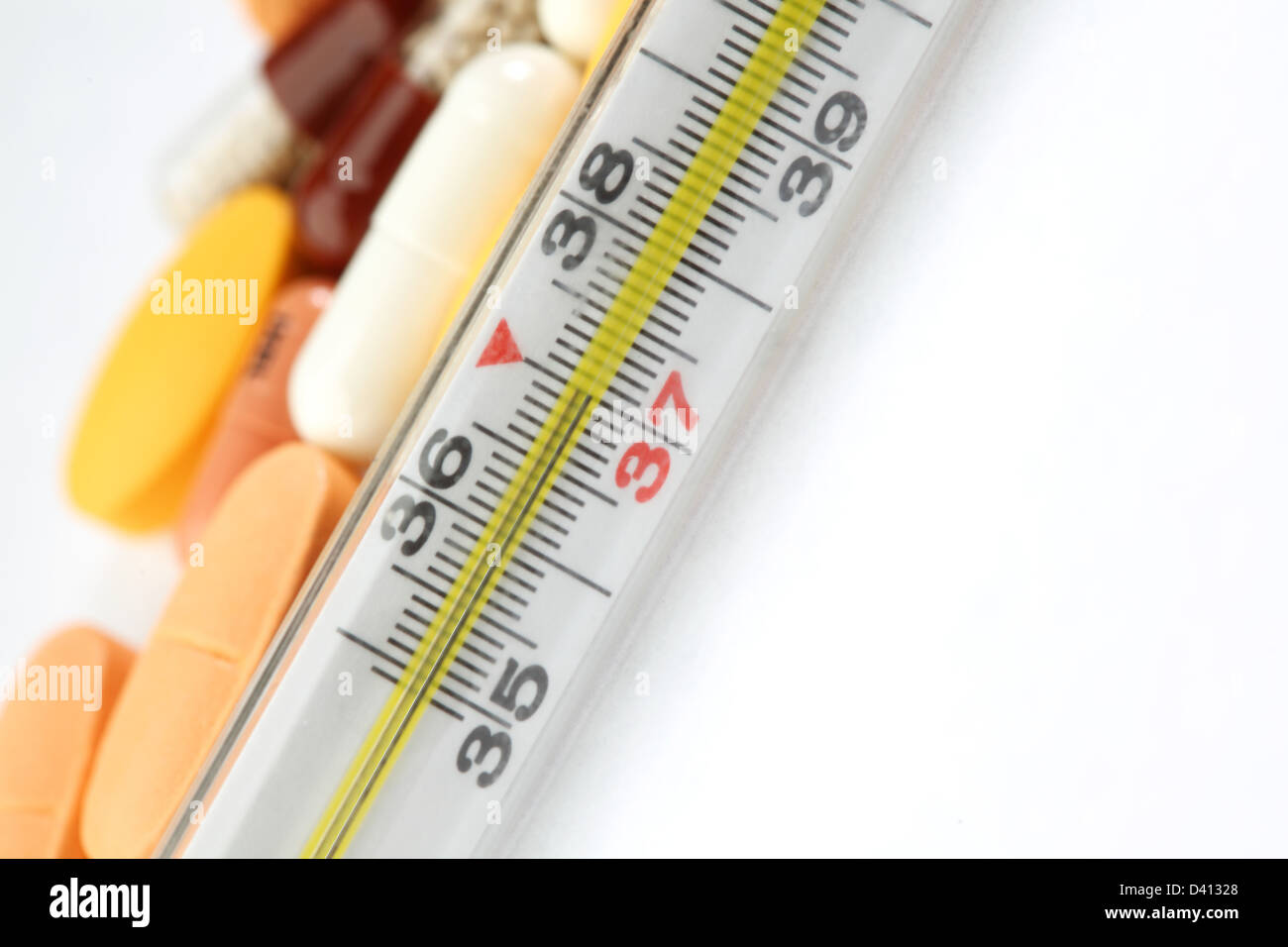 Pills and thermometer Stock Photo - Alamy