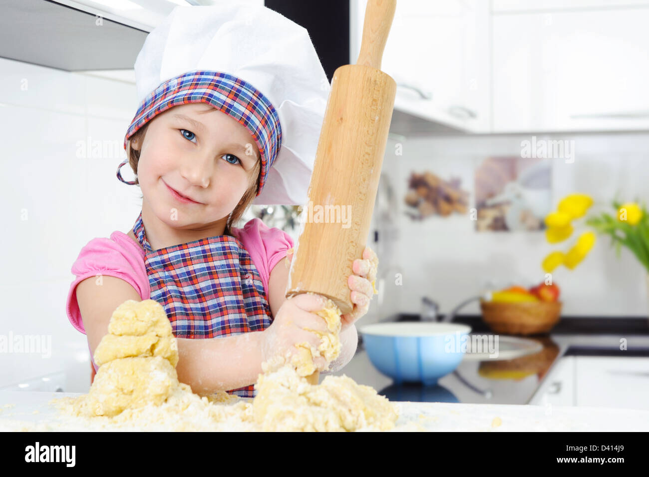 Beautiful little girl with rolling pin in kitchen Stock Photo - Alamy