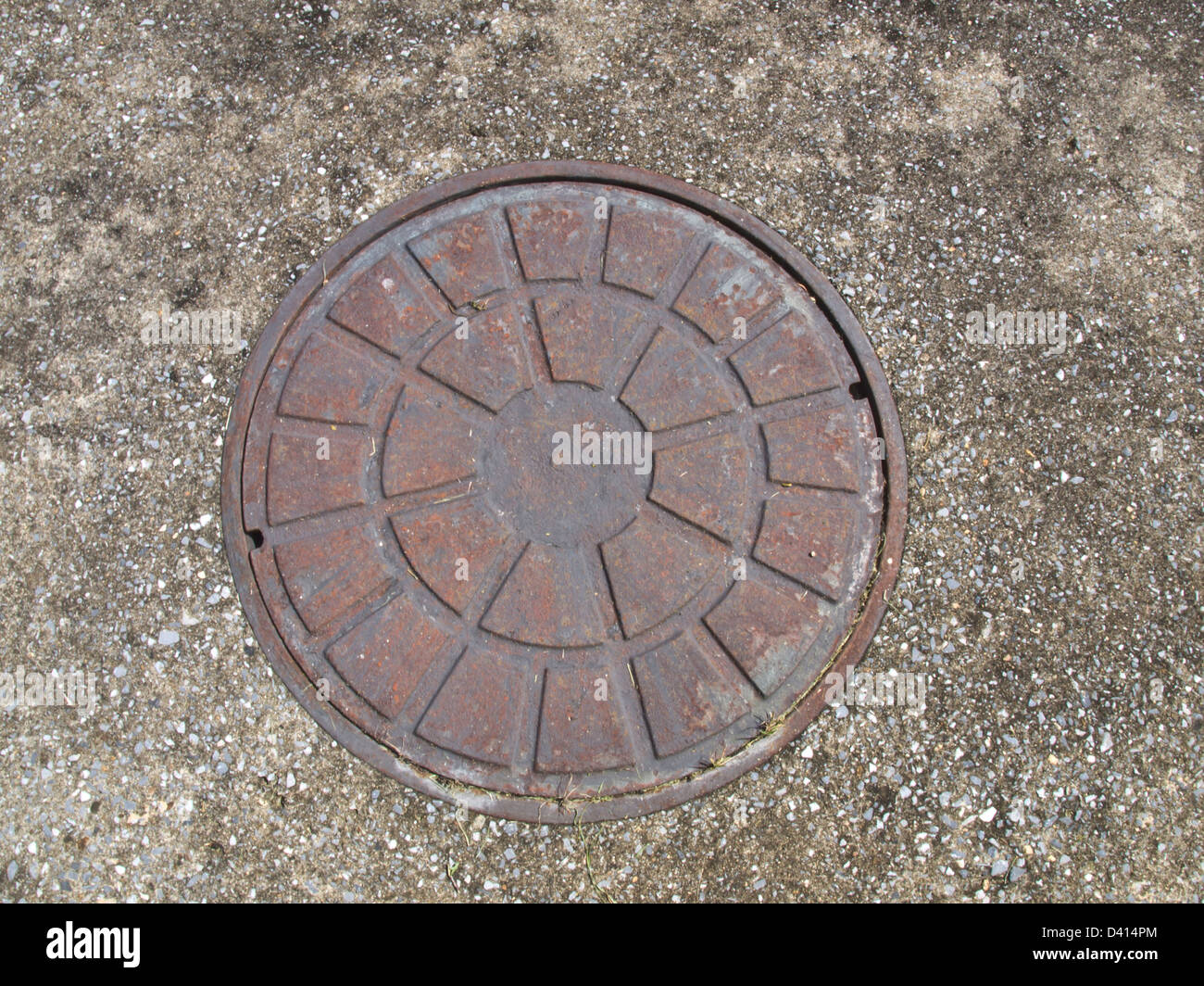 Rusty steel manhole cover Stock Photo - Alamy