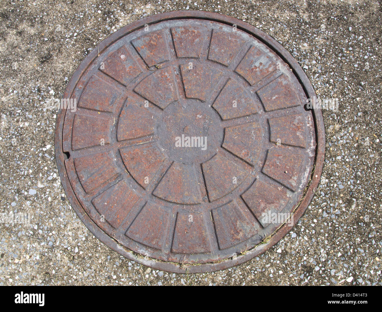 Rusty steel manhole cover Stock Photo - Alamy