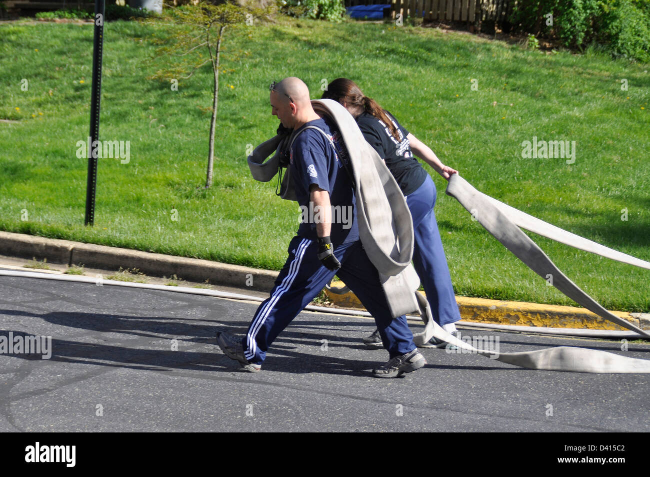 firefighters dragging hose back to the fire truck in Greenbelt Maryland ...