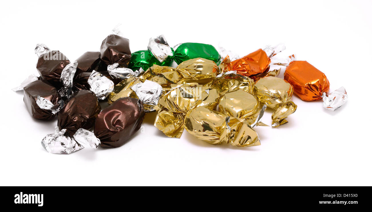 Packed candies in different color placed on a white background Stock ...
