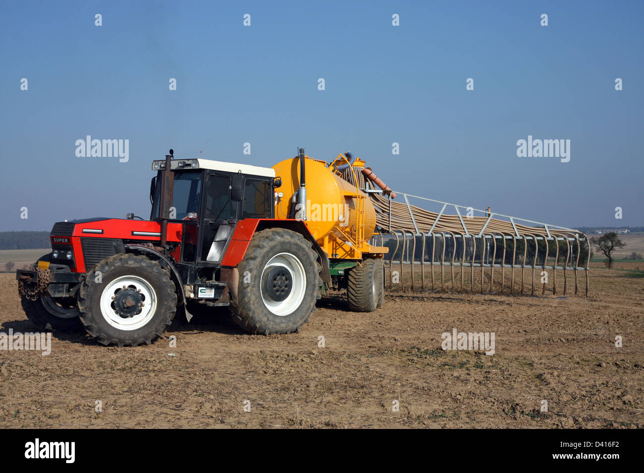 red tractor with yellow sprayer tank Stock Photo - Alamy