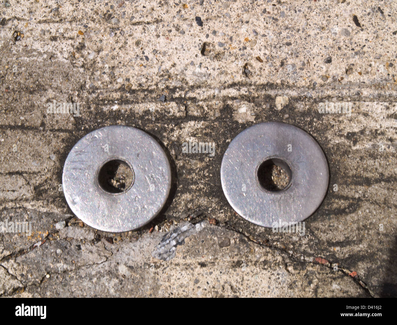 Double metal round plate on concrete Stock Photo - Alamy