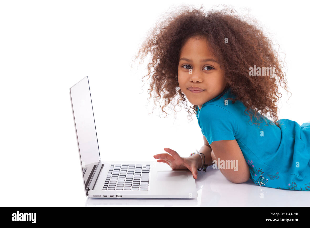 Little african asian girl using a laptop, isolated on white background ...