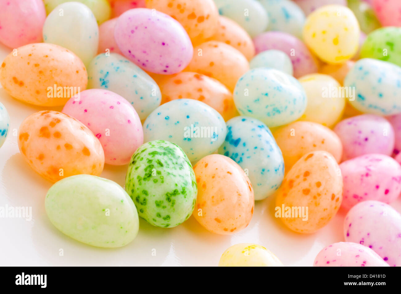 Assorted jelly beans in pastel colors with darker spots Stock Photo - Alamy