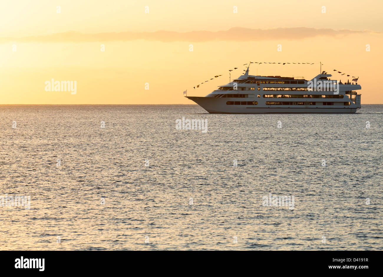 Cruise ship or ferry boat sailing towards setting sun off coast of ...
