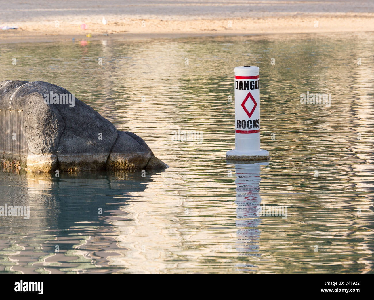Humorous sign for Danger Rocks in small seaside pool with single rock ...