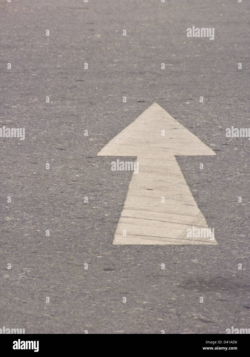 White directional arrow on asphalt pavement Stock Photo - Alamy