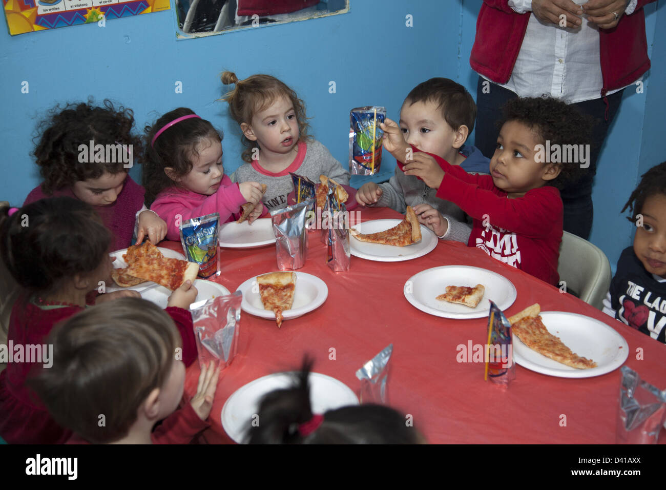 Nursery school children have a pizza party on Valentine's Day at a ...