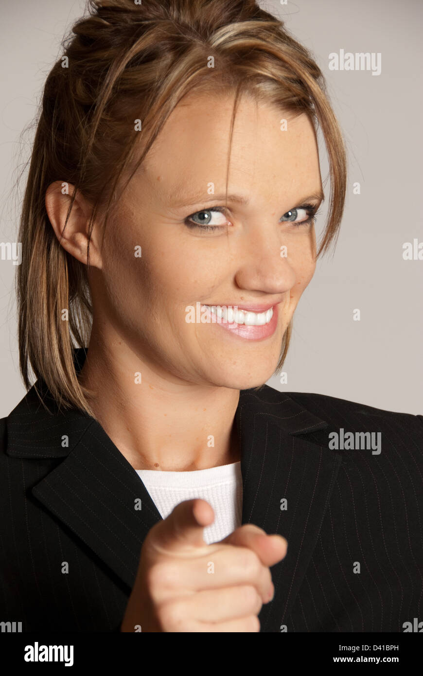 Female business woman pointing at camera smiling Stock Photo - Alamy