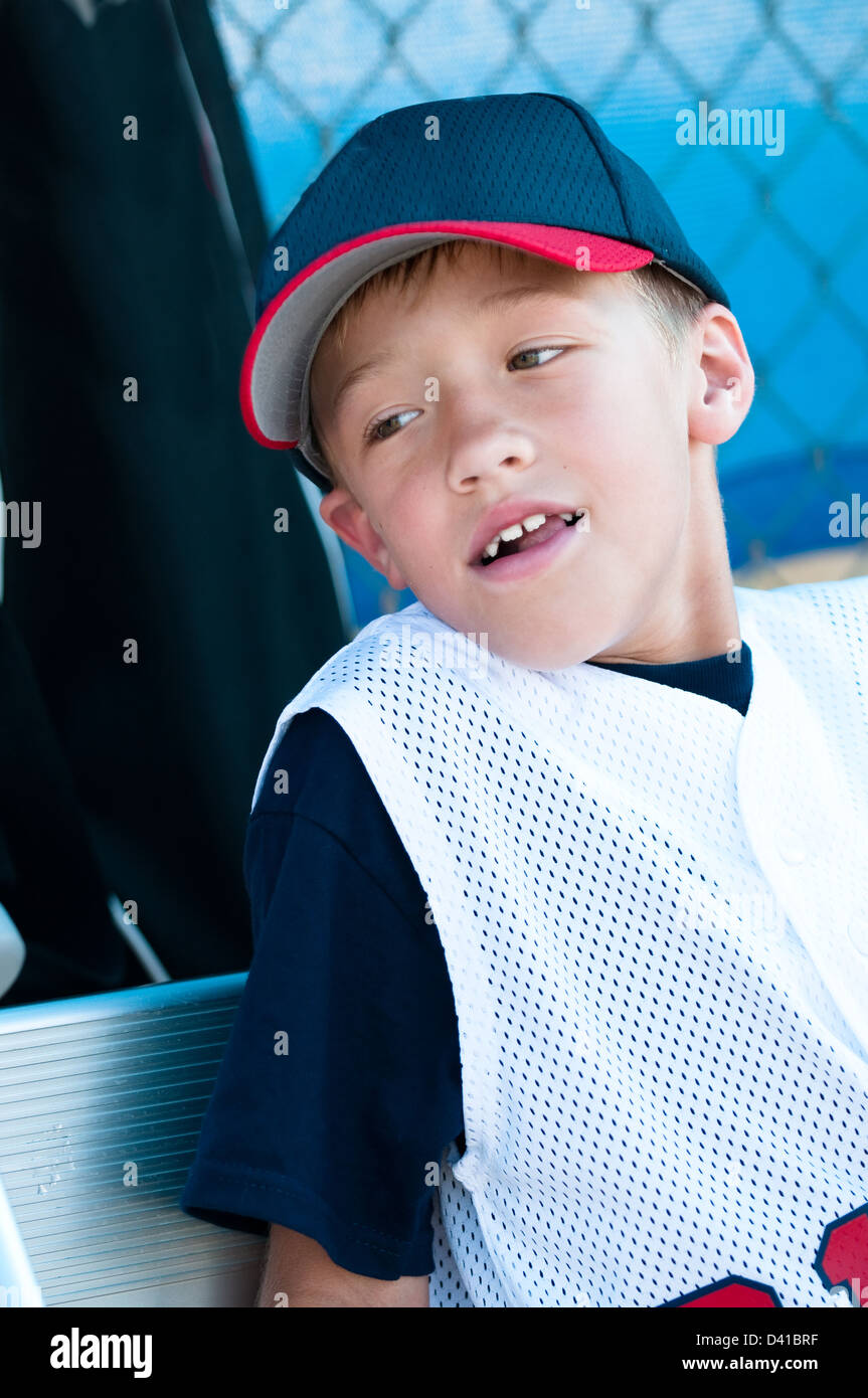 Little league baseball player smiling in dugout Stock Photo - Alamy