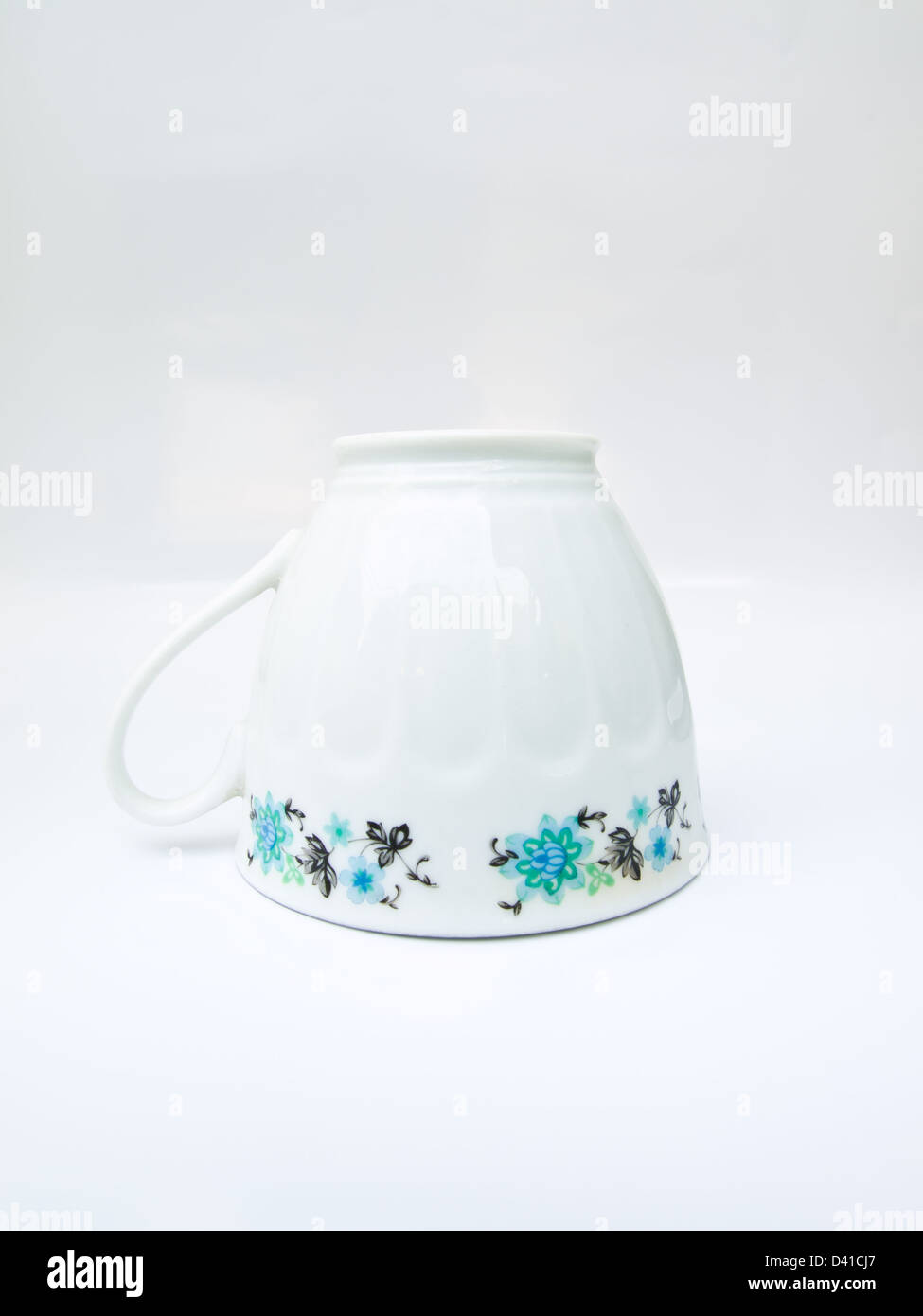A floral pattern tea cup isolated on white background Stock Photo - Alamy